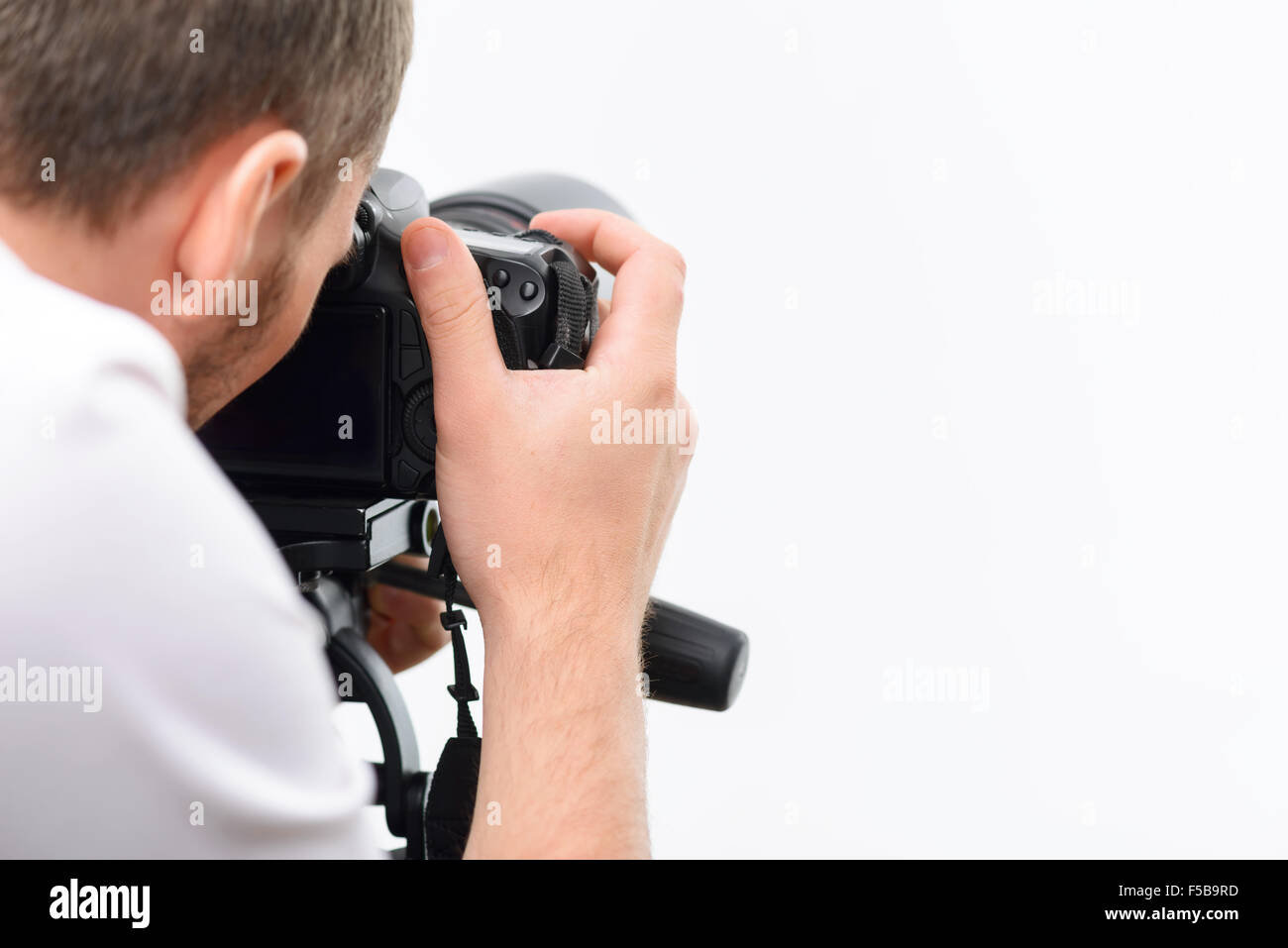 Handsome photographer working with professional camera Stock Photo - Alamy