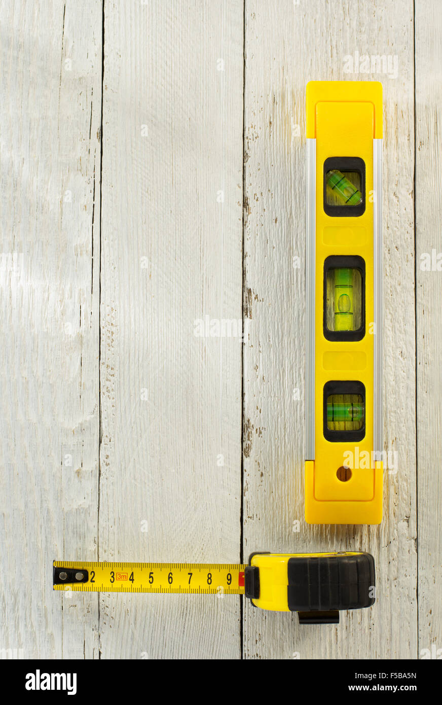 tape measure and pencil on wooden texture Stock Photo - Alamy