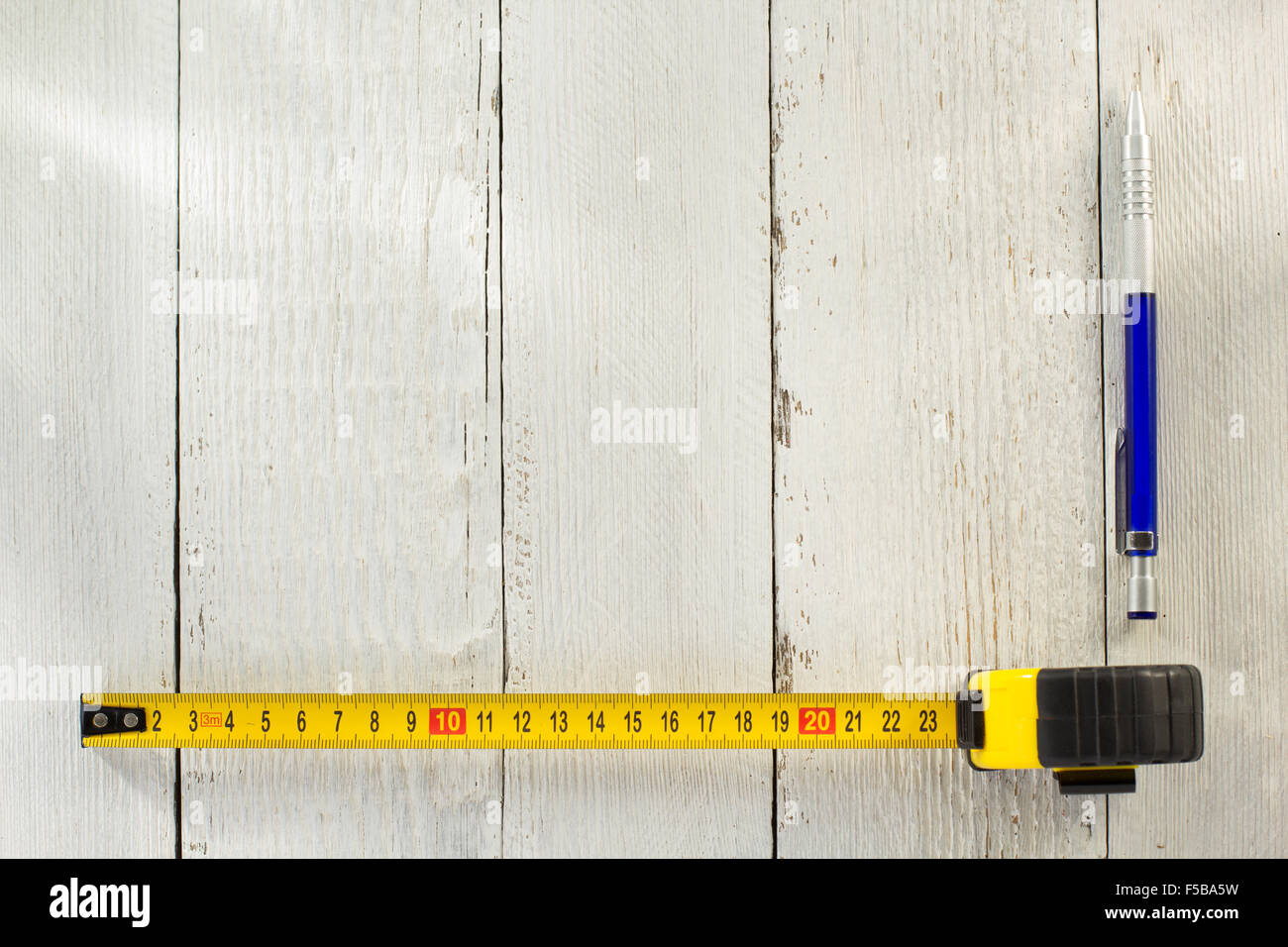 tape measure and pencil on wooden texture Stock Photo - Alamy