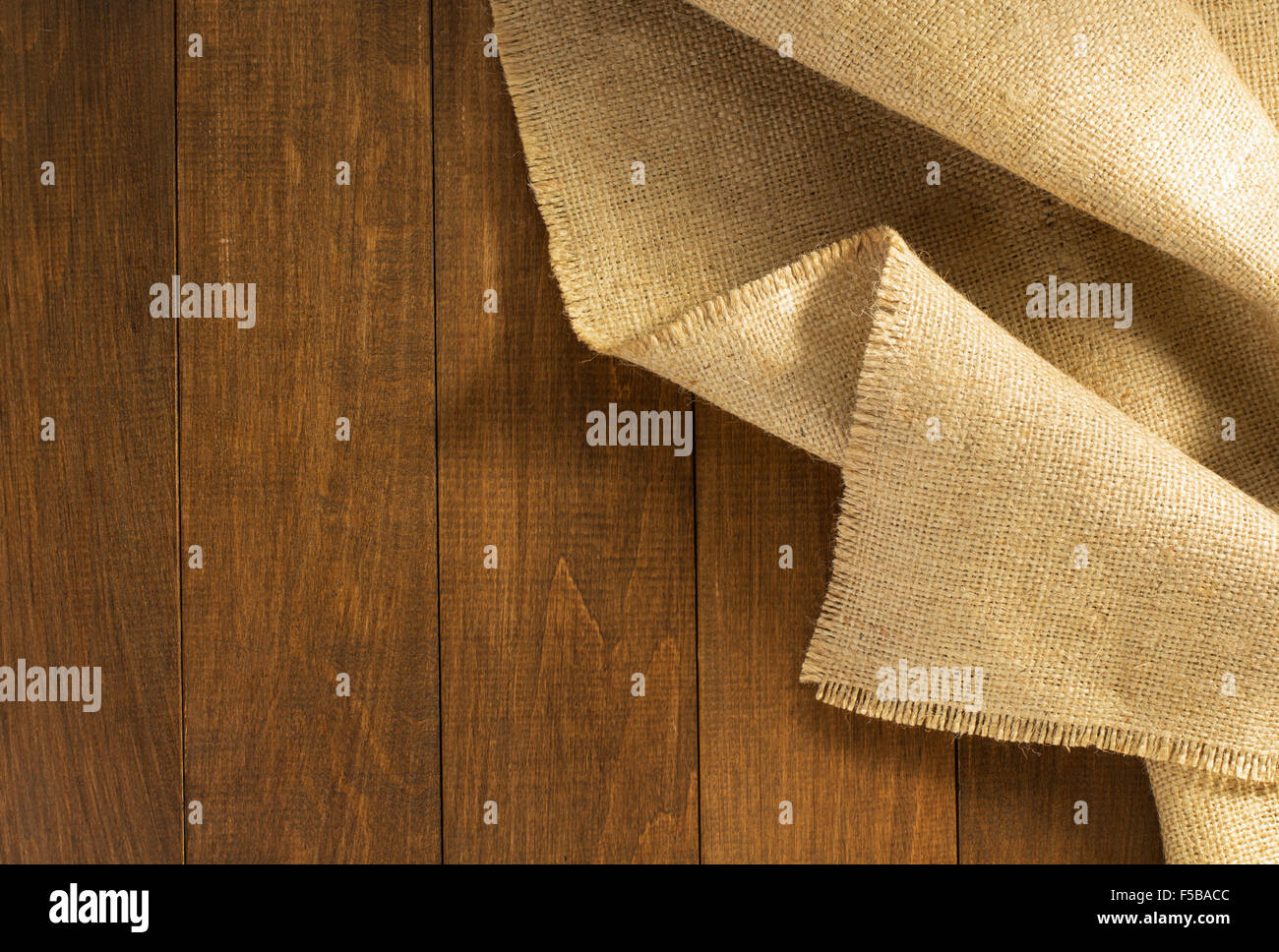burlap hessian sacking on wooden background Stock Photo - Alamy