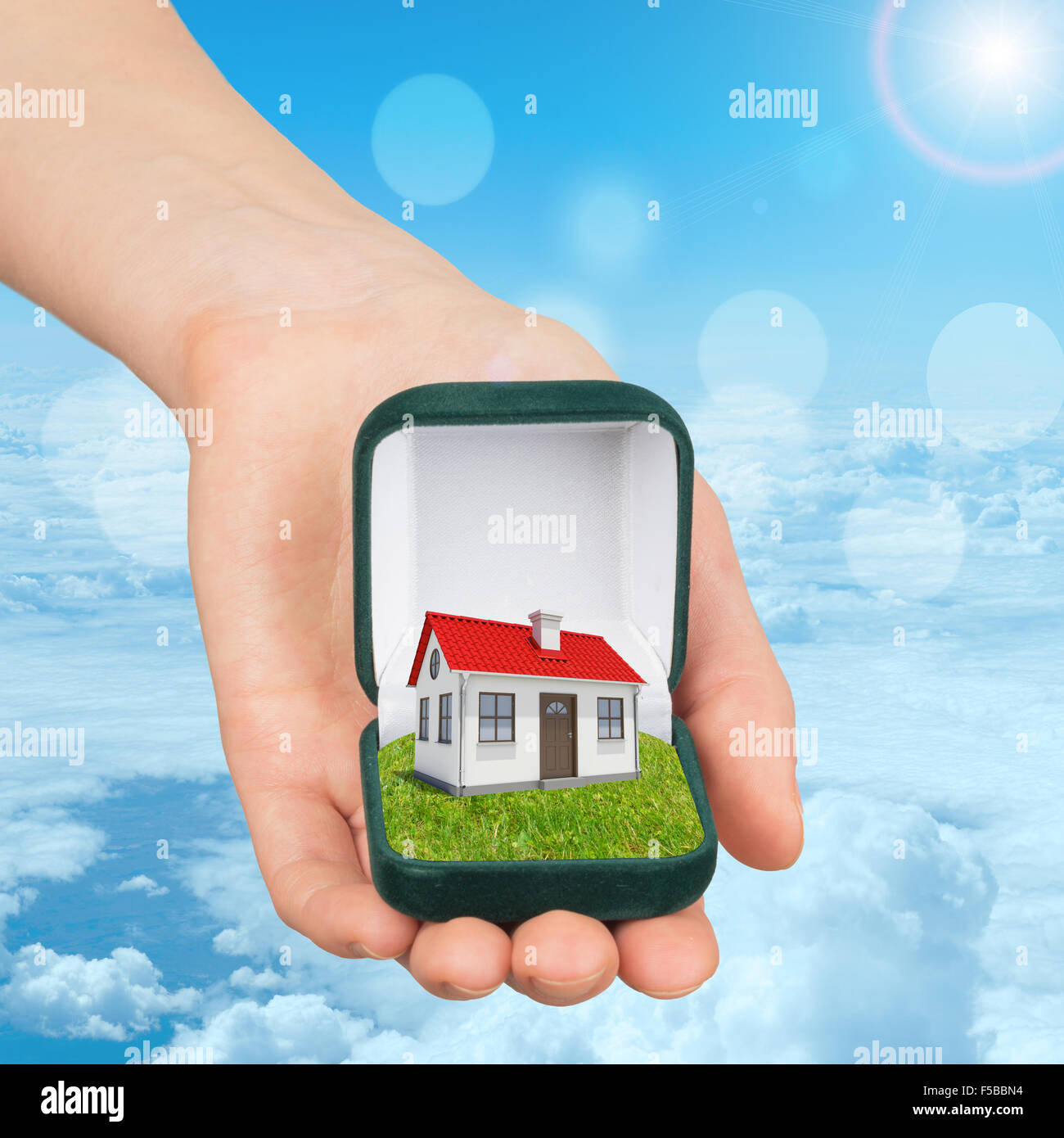 Empty ring box with house in humans hand Stock Photo - Alamy