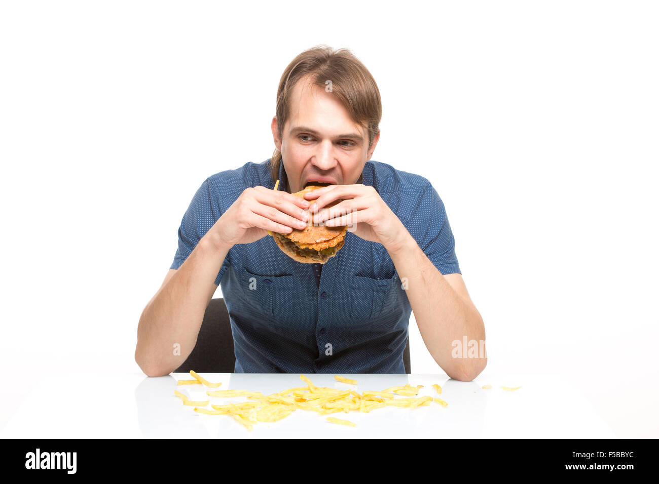 Man eating burger chips Cut Out Stock Images & Pictures - Alamy