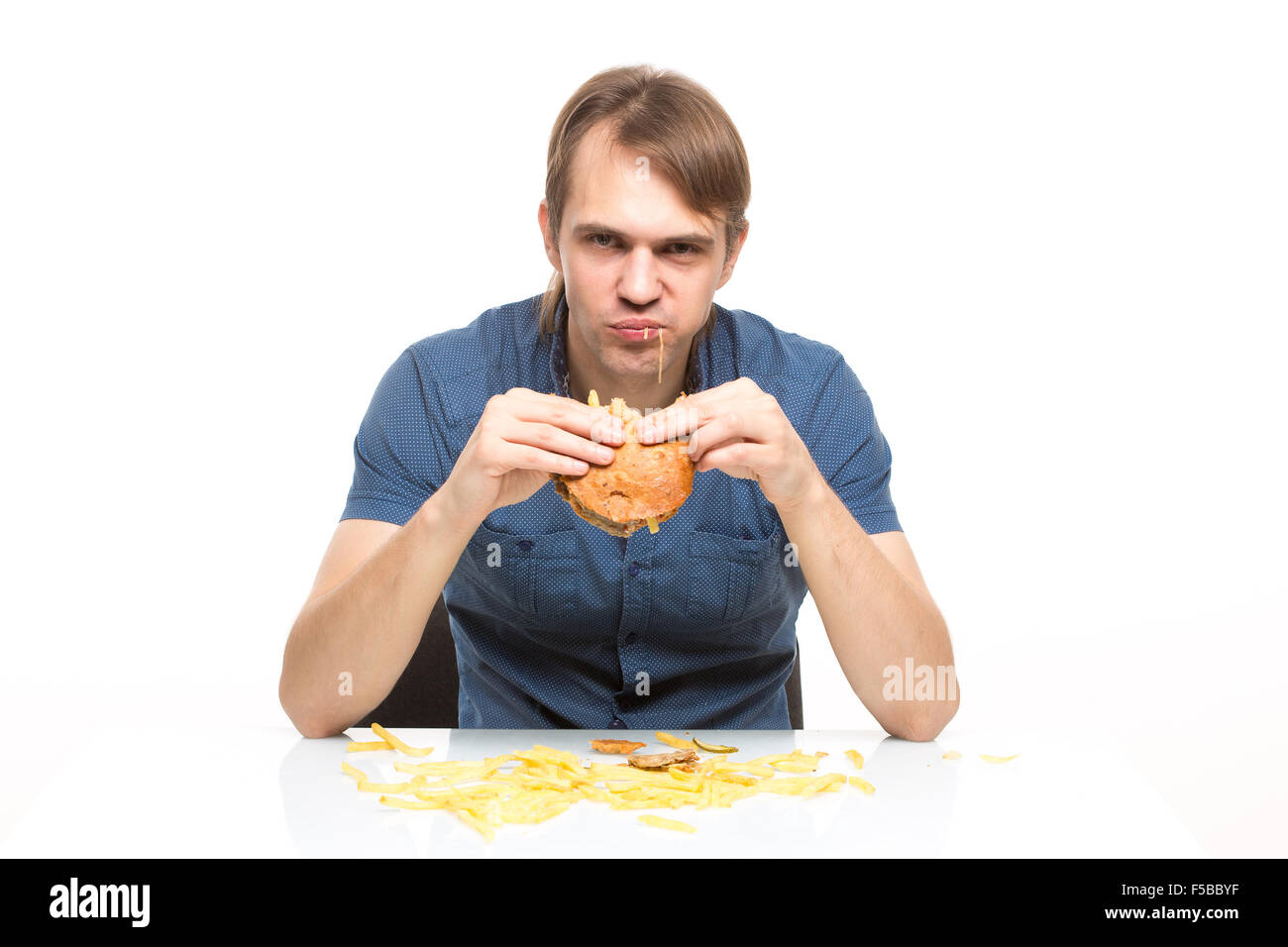 man is not careful eating tasteless burger Stock Photo - Alamy