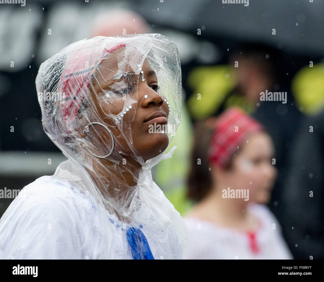 Performers in colourful costumes dance through the rain during the ...
