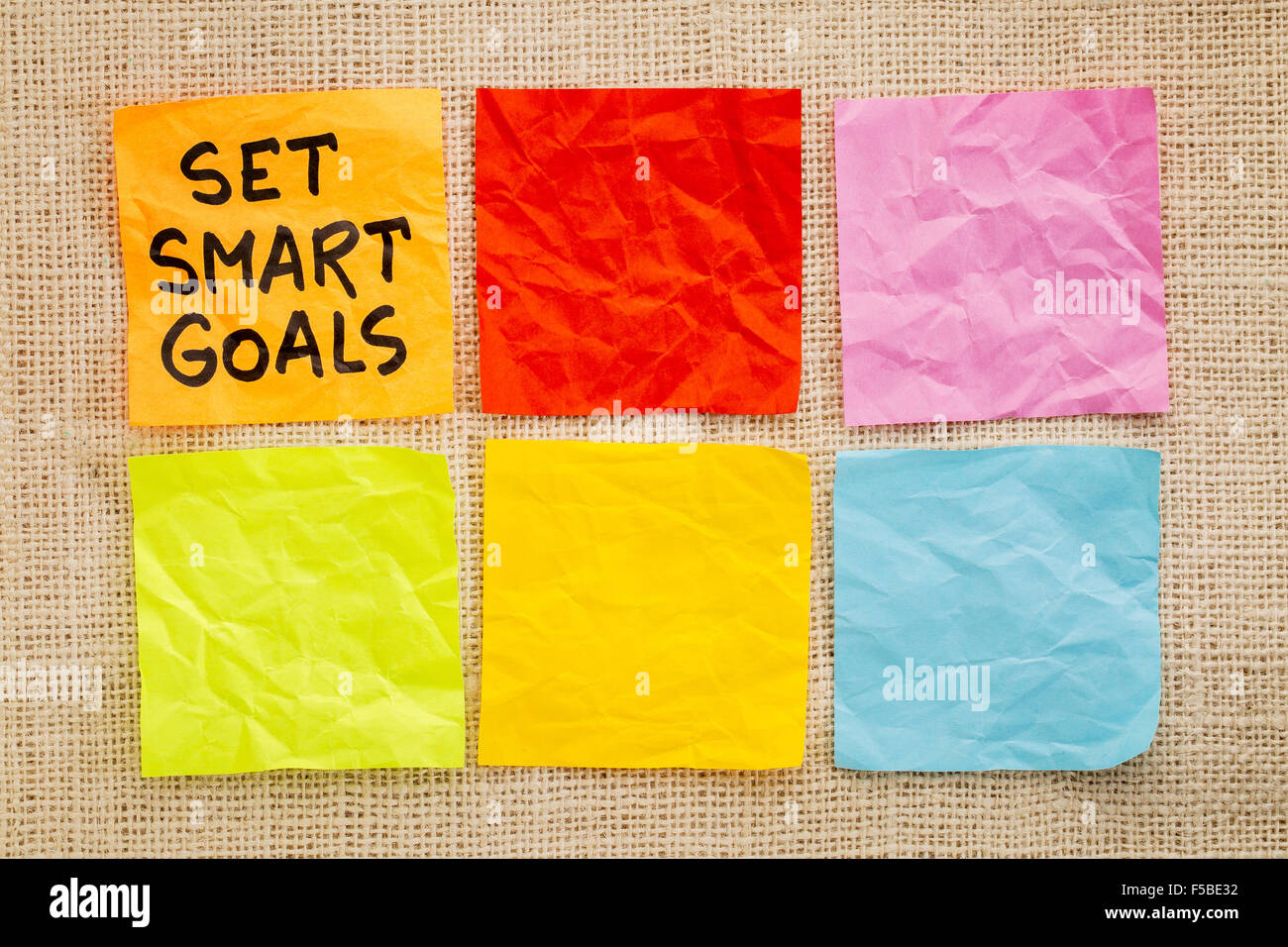 set smart goals - handwriting on sticky notes against burlap canvas ...