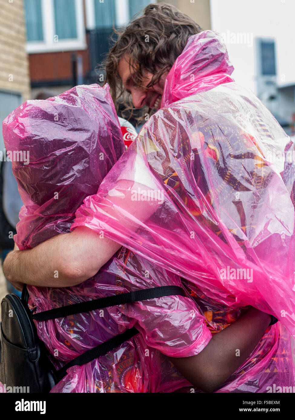 Performers in colourful costumes dance through the rain during the ...