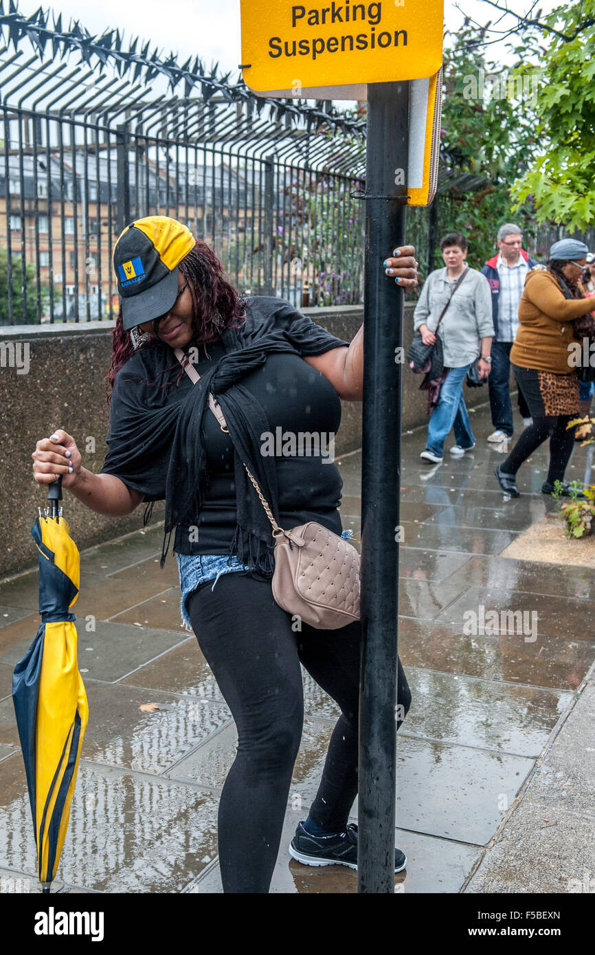 Performers in colourful costumes dance through the rain during the ...