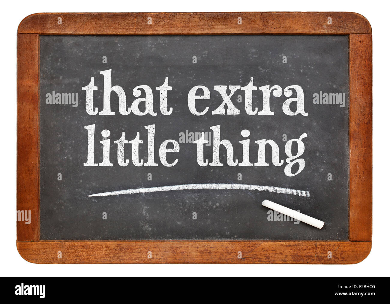 That little extra thing -white chalk text on a vintage slate blackboard ...