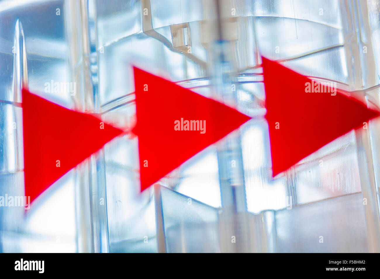 Abstract, distorted, image of red direction arrows on a sweet / bubble ...