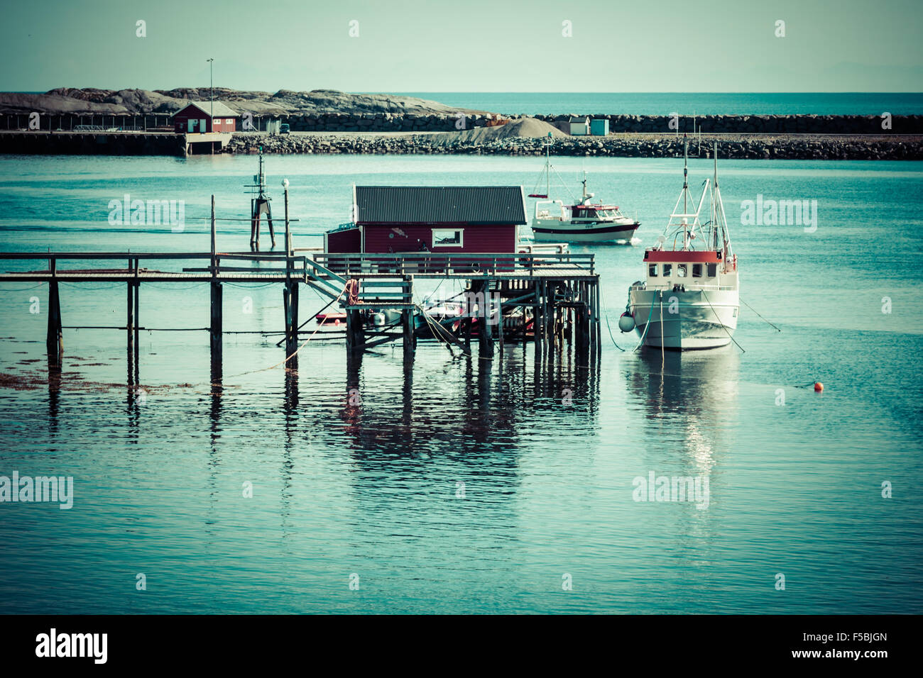 Typical Norwegian fishing village with traditional red rorbu huts ...