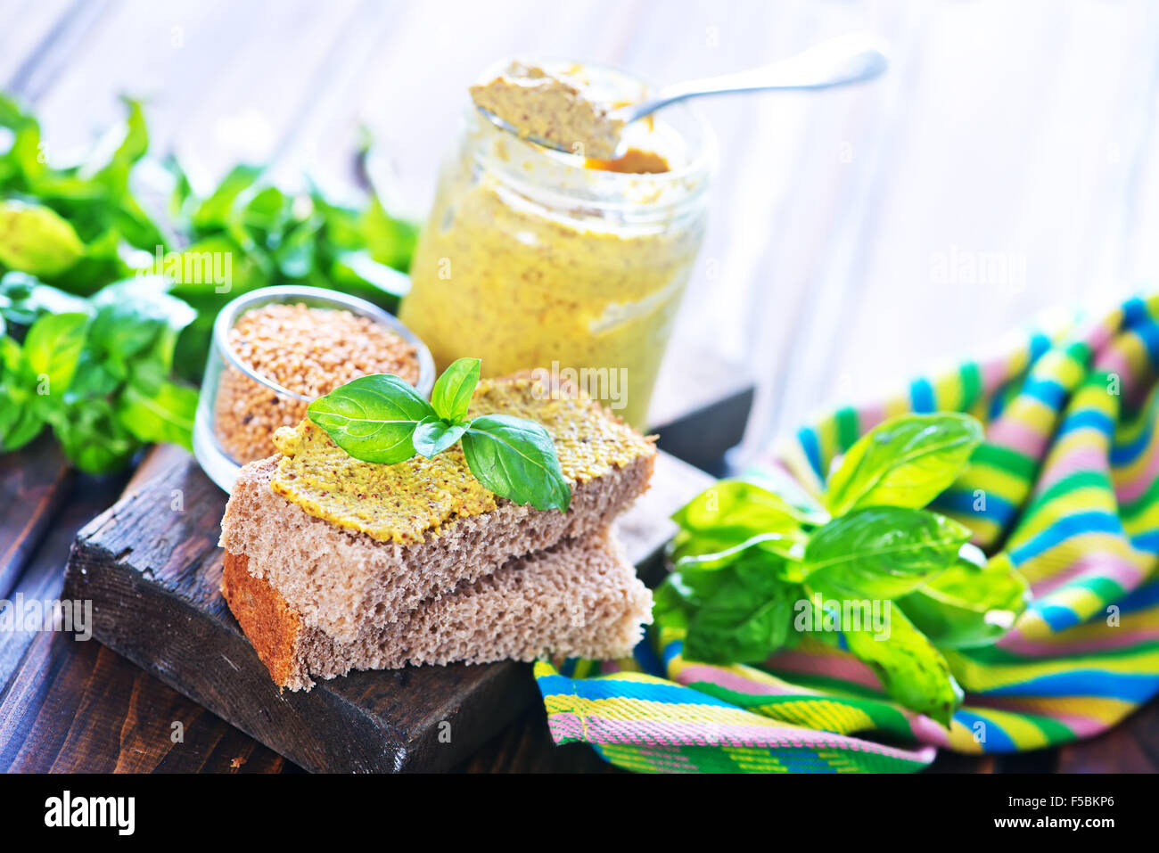 mustard in glass bank and on a table Stock Photo - Alamy