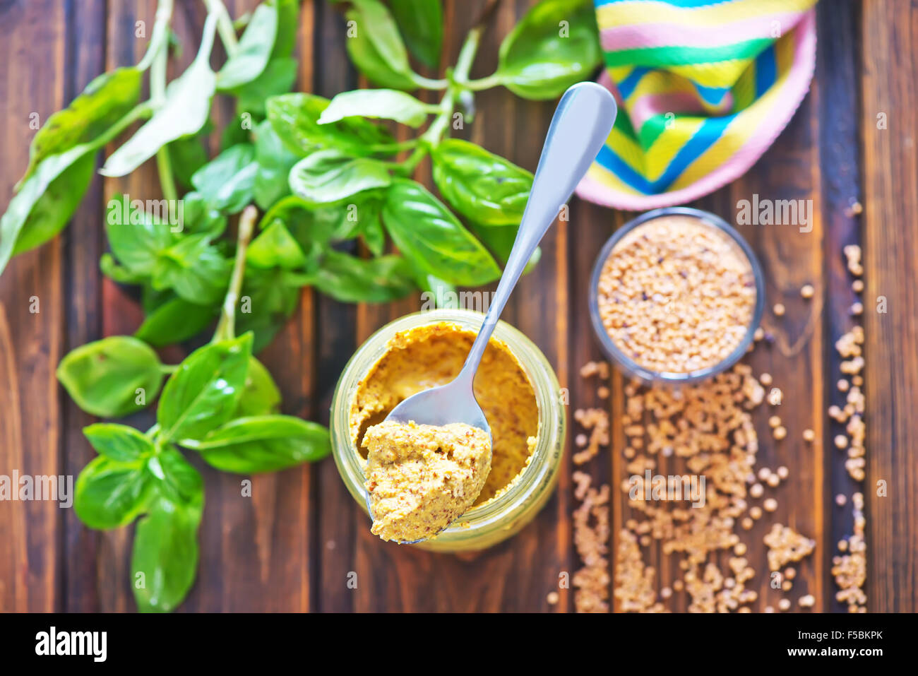 mustard in glass bank and on a table Stock Photo - Alamy