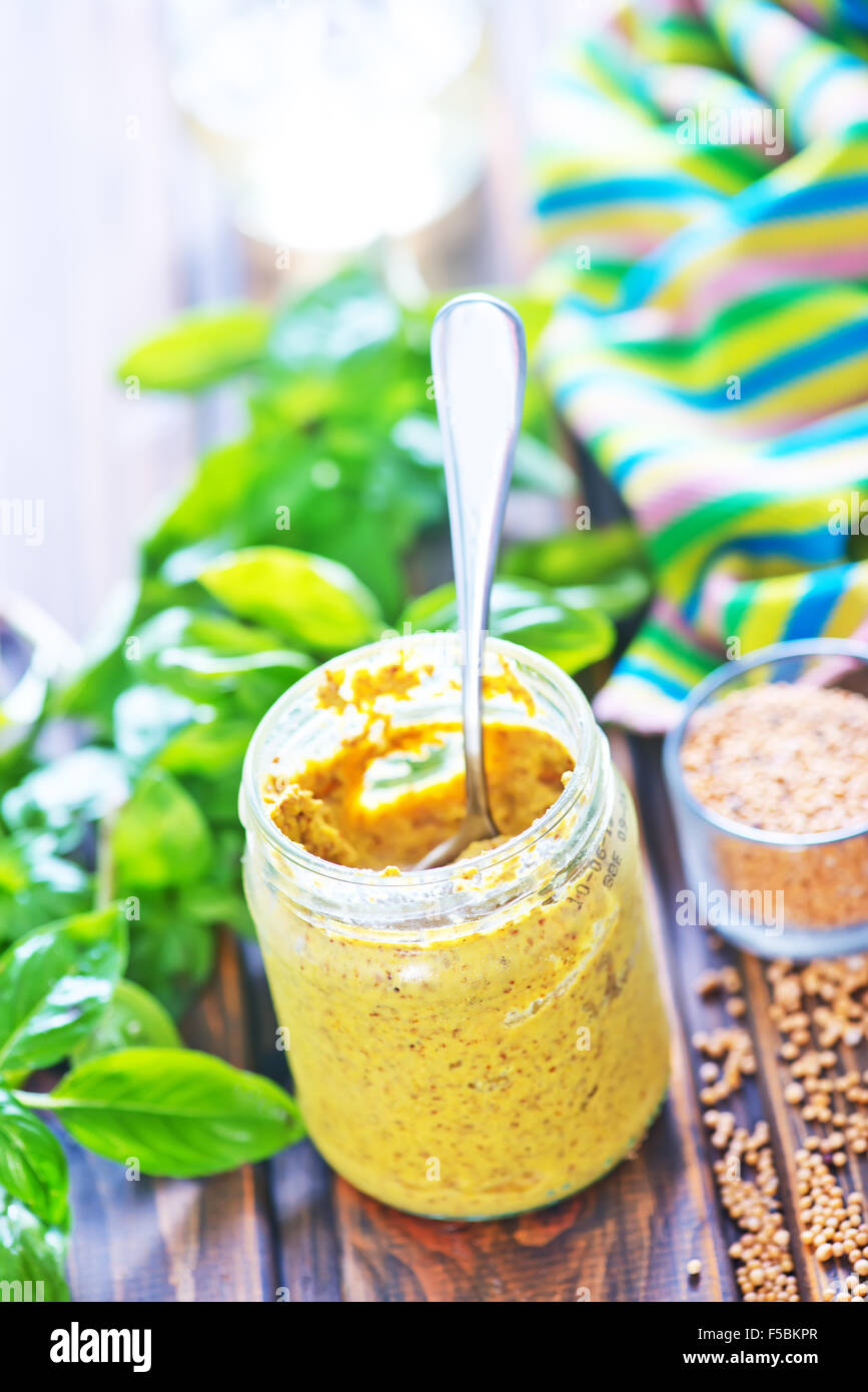 mustard in glass bank and on a table Stock Photo - Alamy