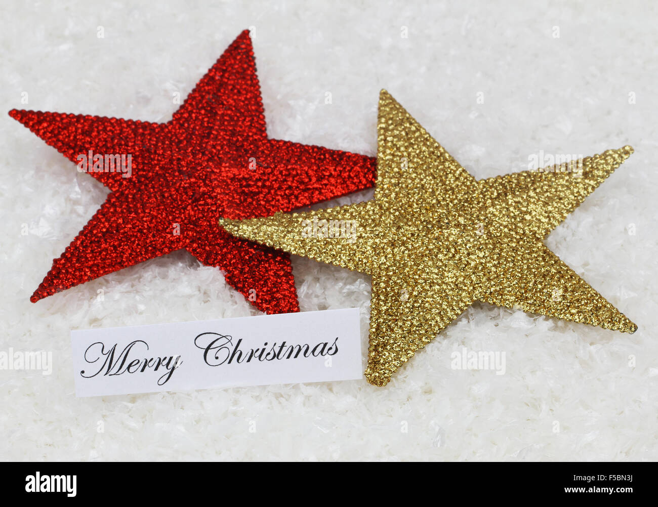 Merry Christmas card with red and golden stars covered with glitter on ...