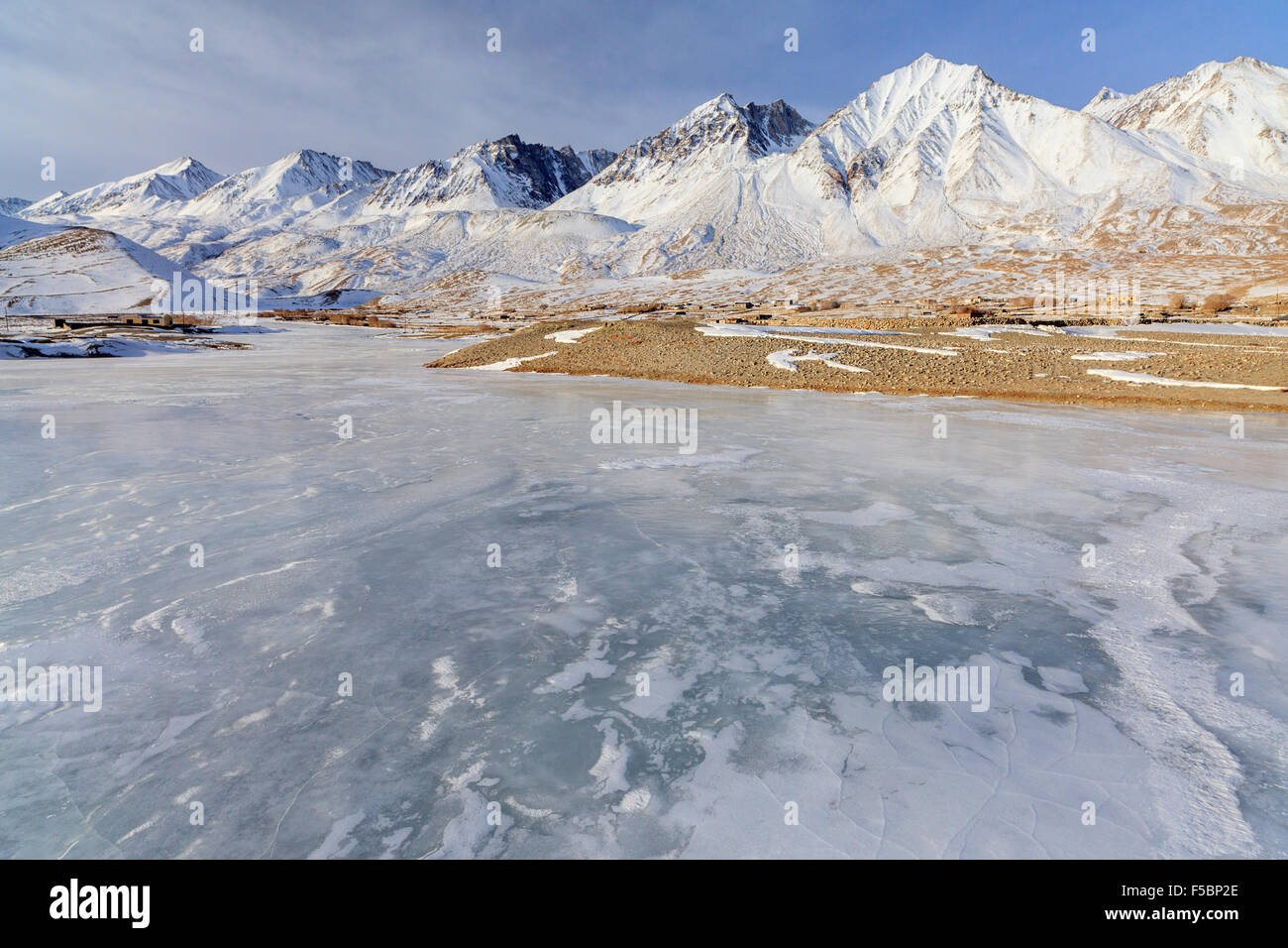 The frozen Maan river flowing from the lofty glaciers high up in the ...