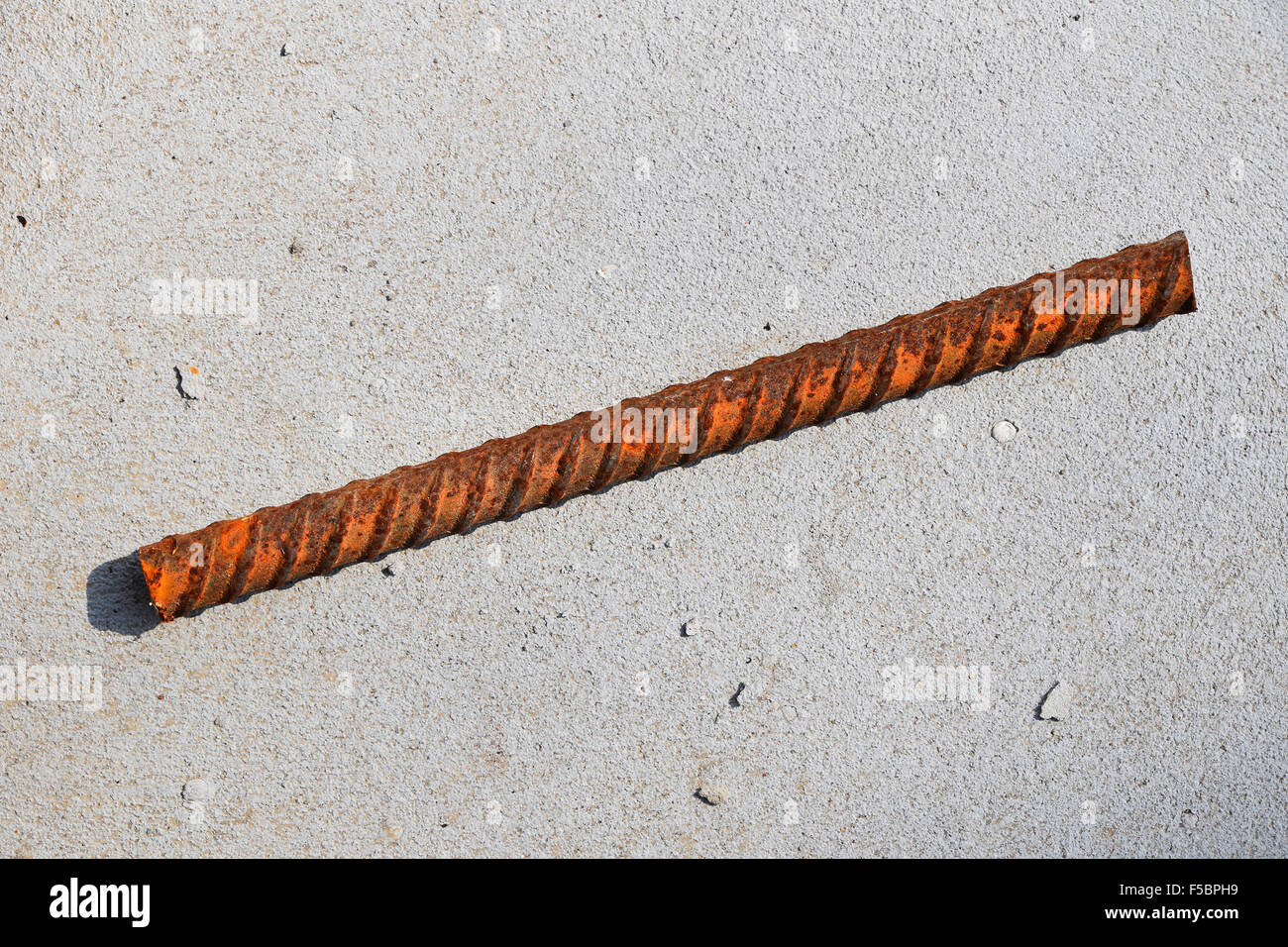 Cut piece of corroded stained rusty metal armature fitting on bubbled ...
