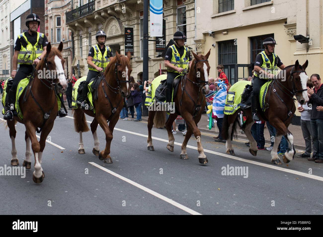Mounted police officers riding horses during a Wales rugby game Stock ...