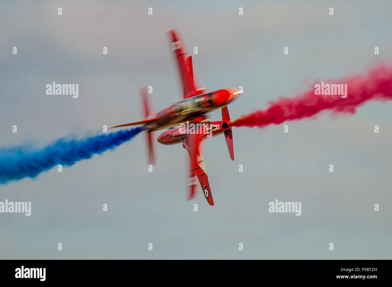 The RAF aerobatic display team the Red Arrows performing their 'opposition pass' at an airshow ...