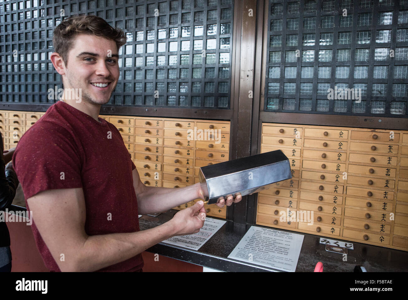 man holding chopstick fortune shaker Stock Photo - Alamy