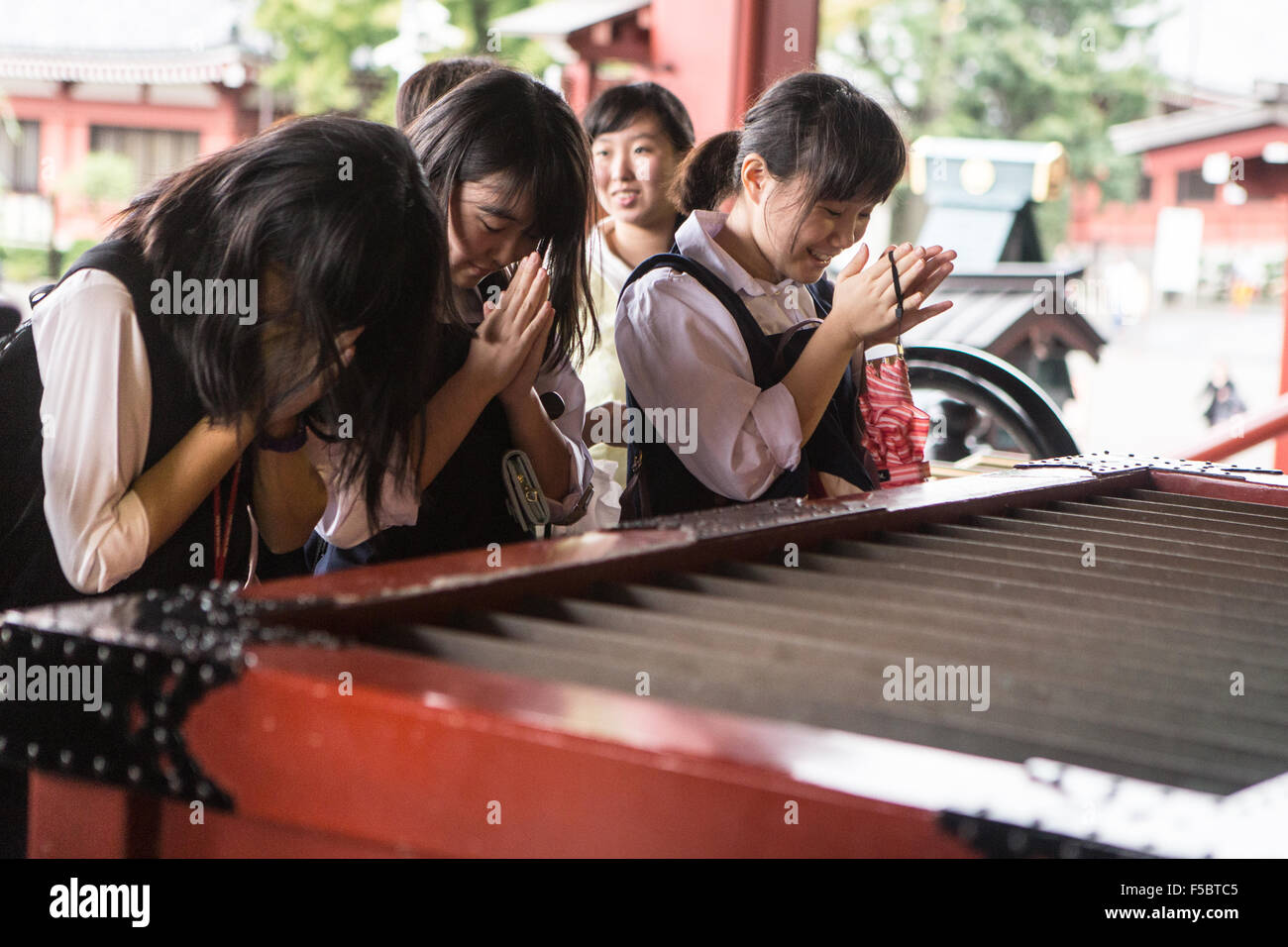 Girls praying at Temple Stock Photo - Alamy