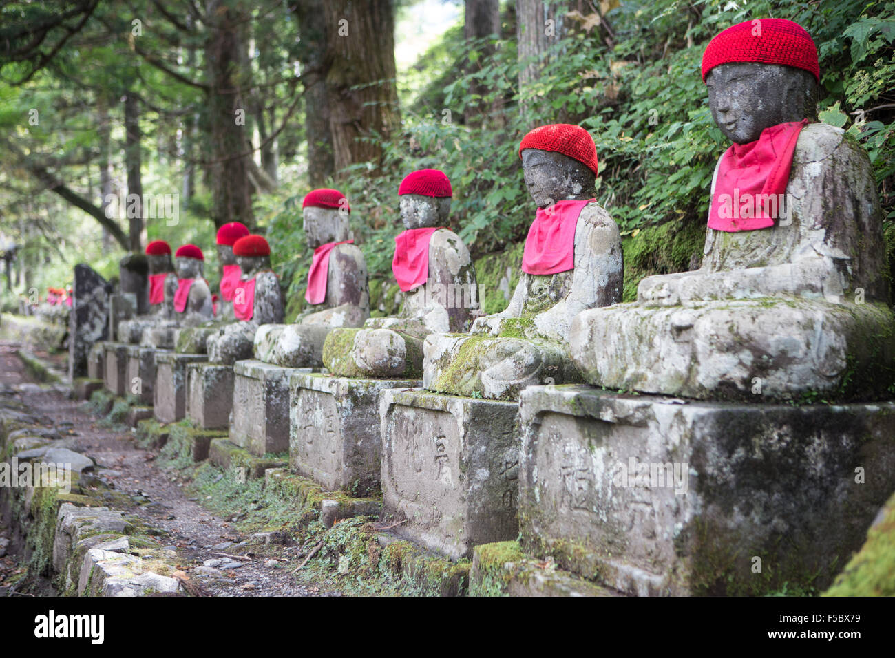 red capped stone Buddha Stock Photo - Alamy