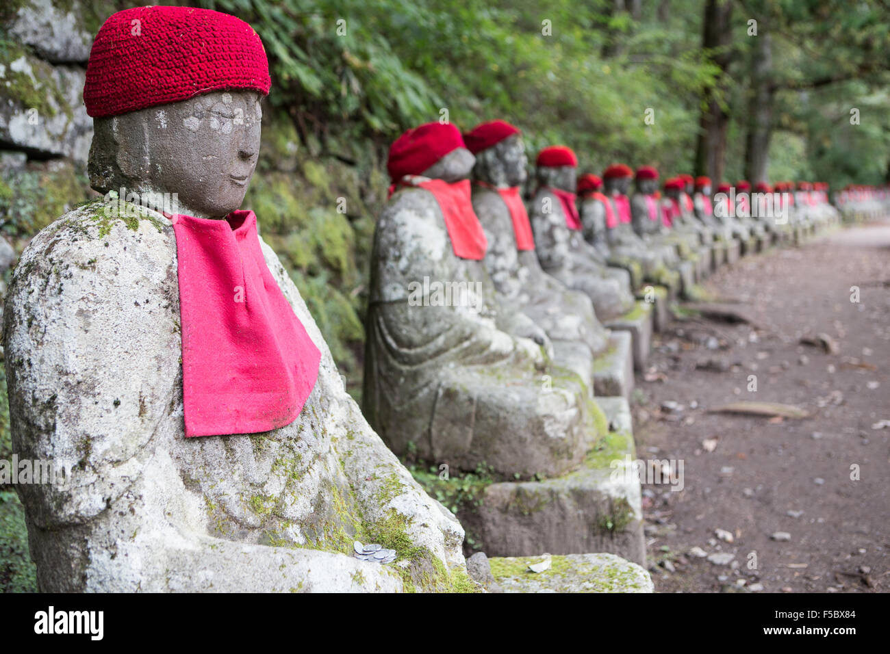 red capped stone Buddha Stock Photo - Alamy
