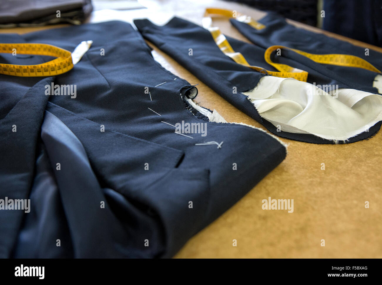 Various components of a gents jacket laid out on a table Stock Photo ...