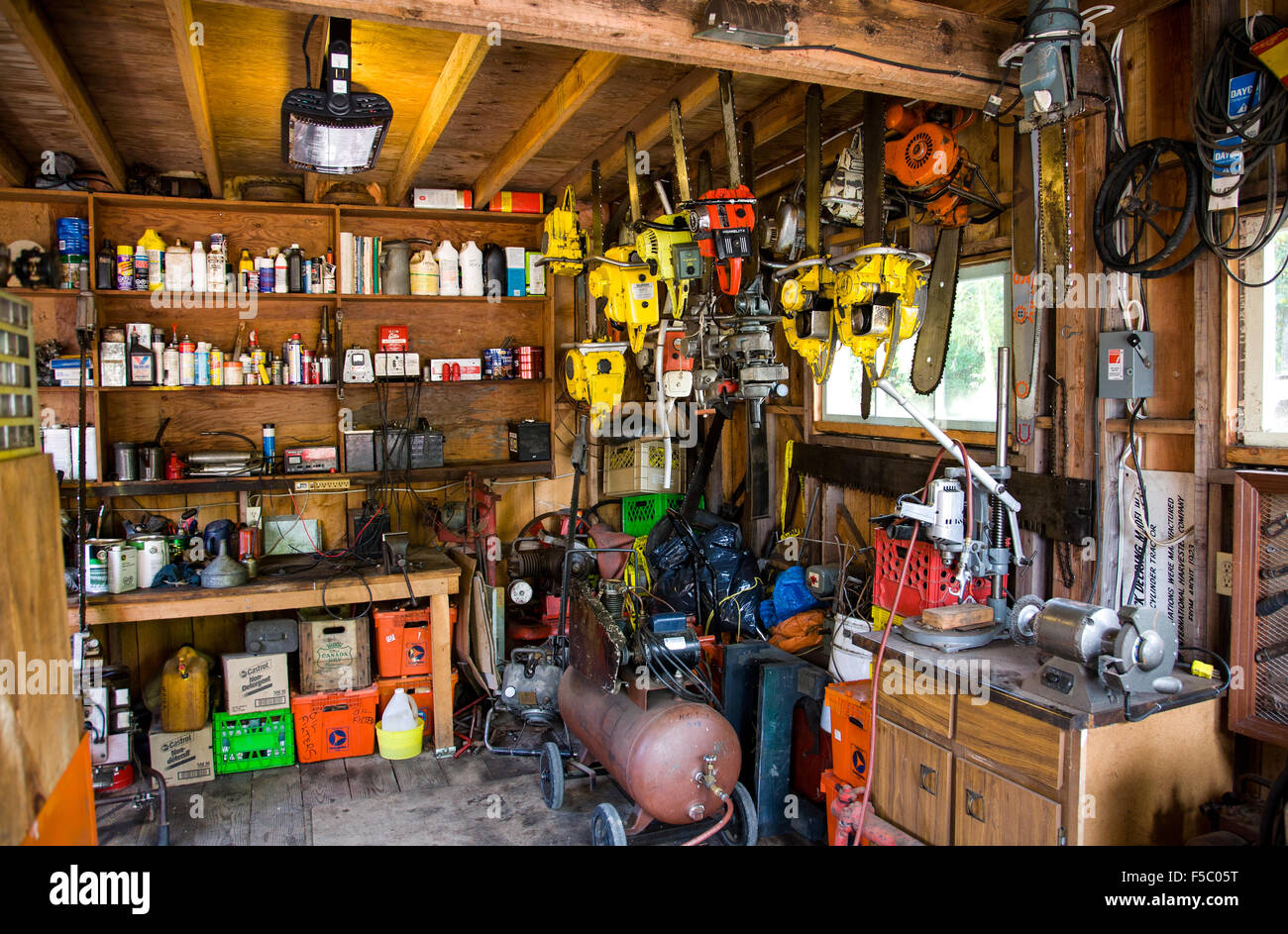 old workshop shed with equipment, power tools and supplies Stock Photo ...