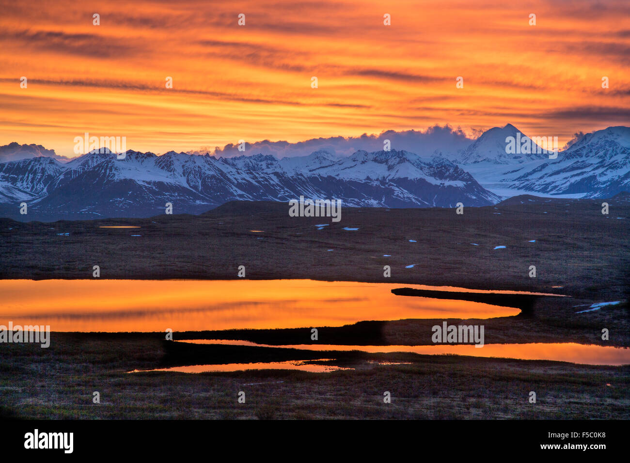 Sunset over the Delta River flowing toward the Amphitheater Mountains ...