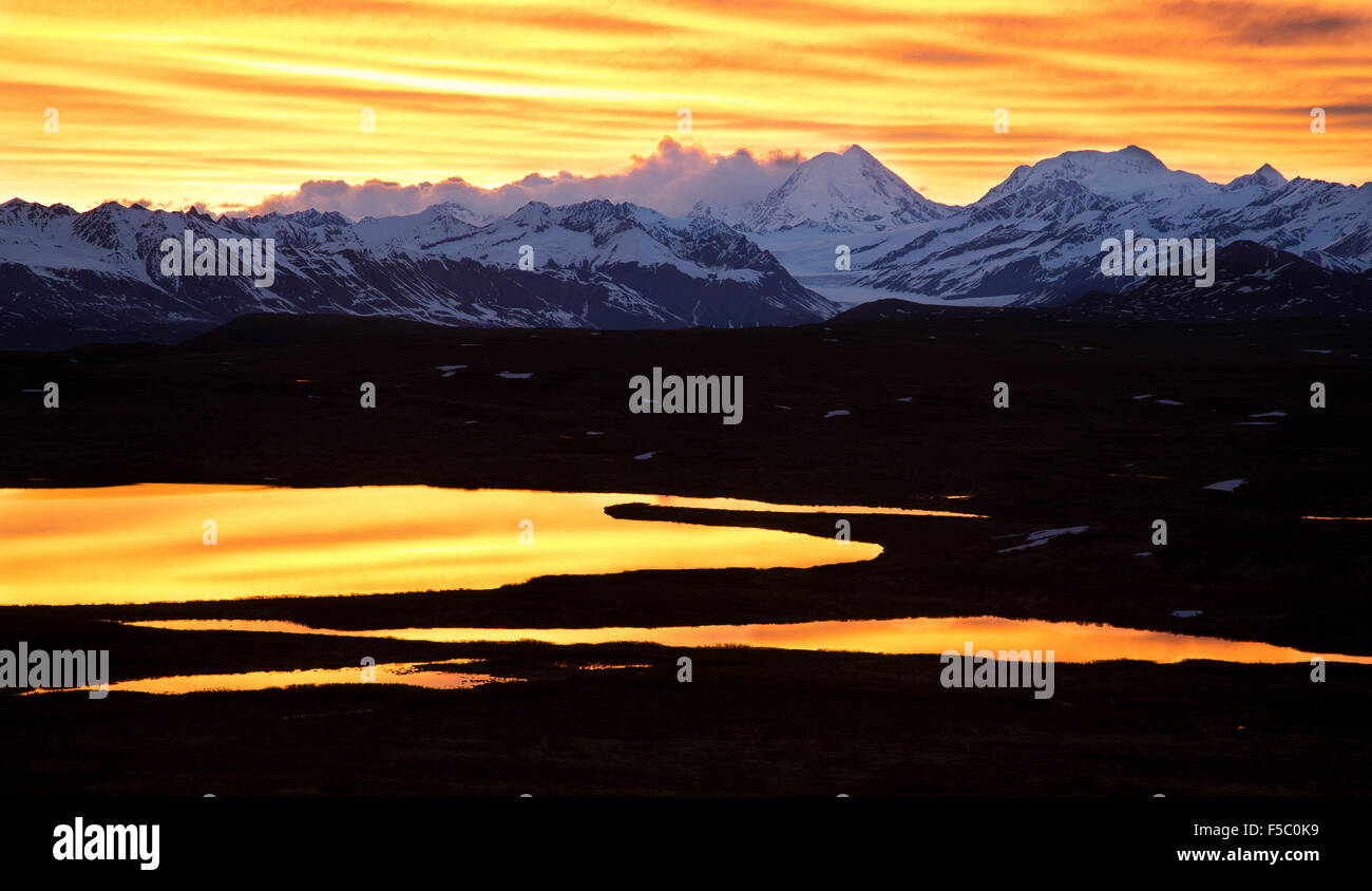 Sunset over the Delta River flowing toward the Amphitheater Mountains ...