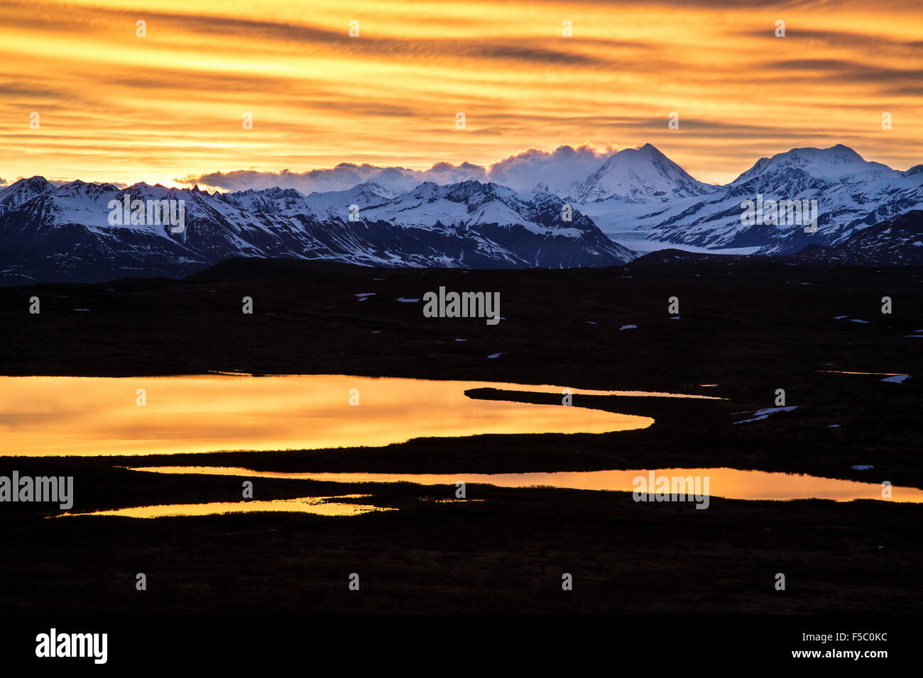Sunset over the Delta River flowing toward the Amphitheater Mountains ...
