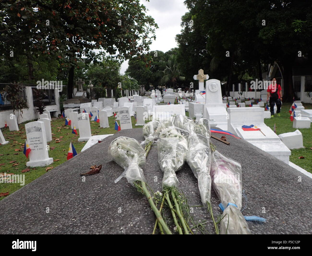 Manila, Philippines. 01st Nov, 2015. Flags are placed on the tomb of ...