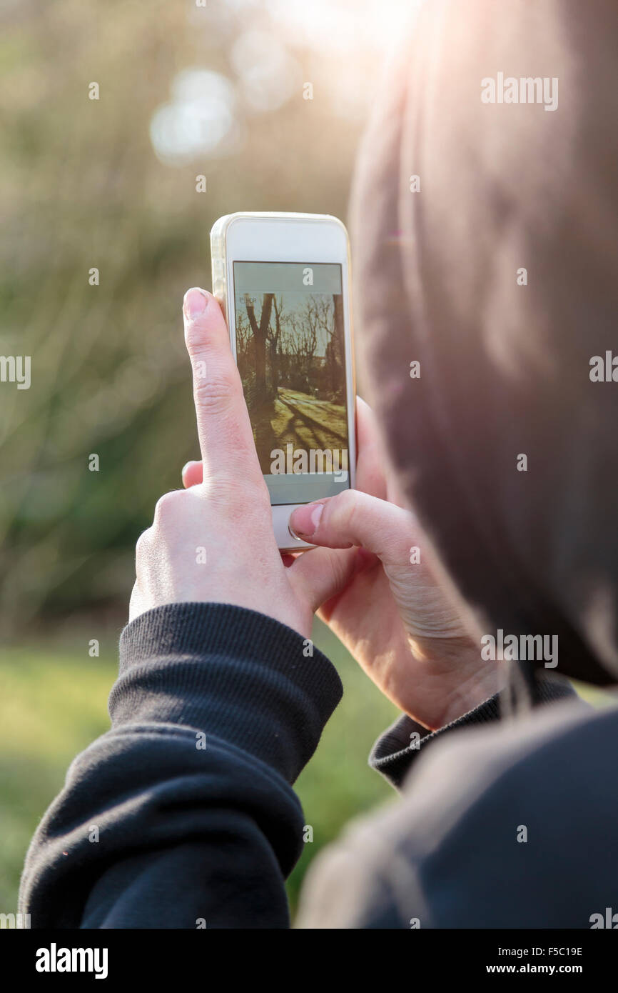 teenage boy taking photographs with a smart phone Stock Photo - Alamy