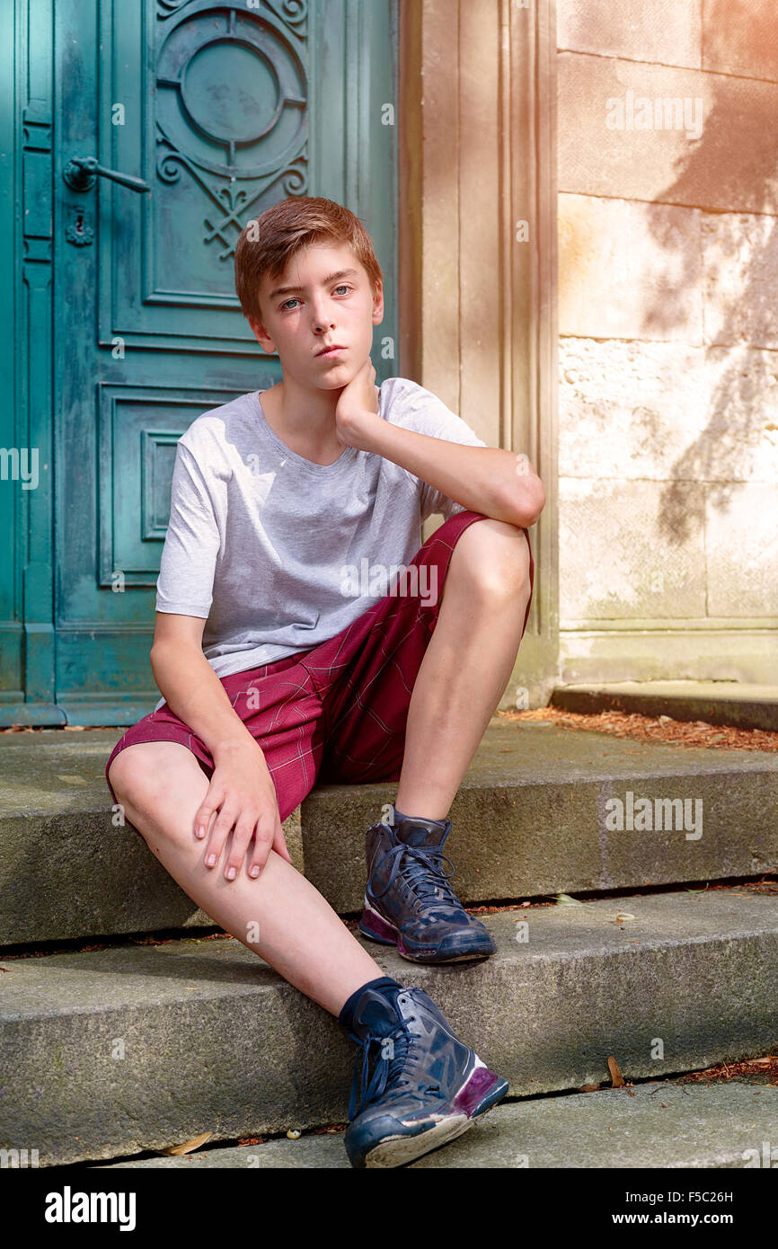 portrait of a sitting teenage boy in summer Stock Photo - Alamy