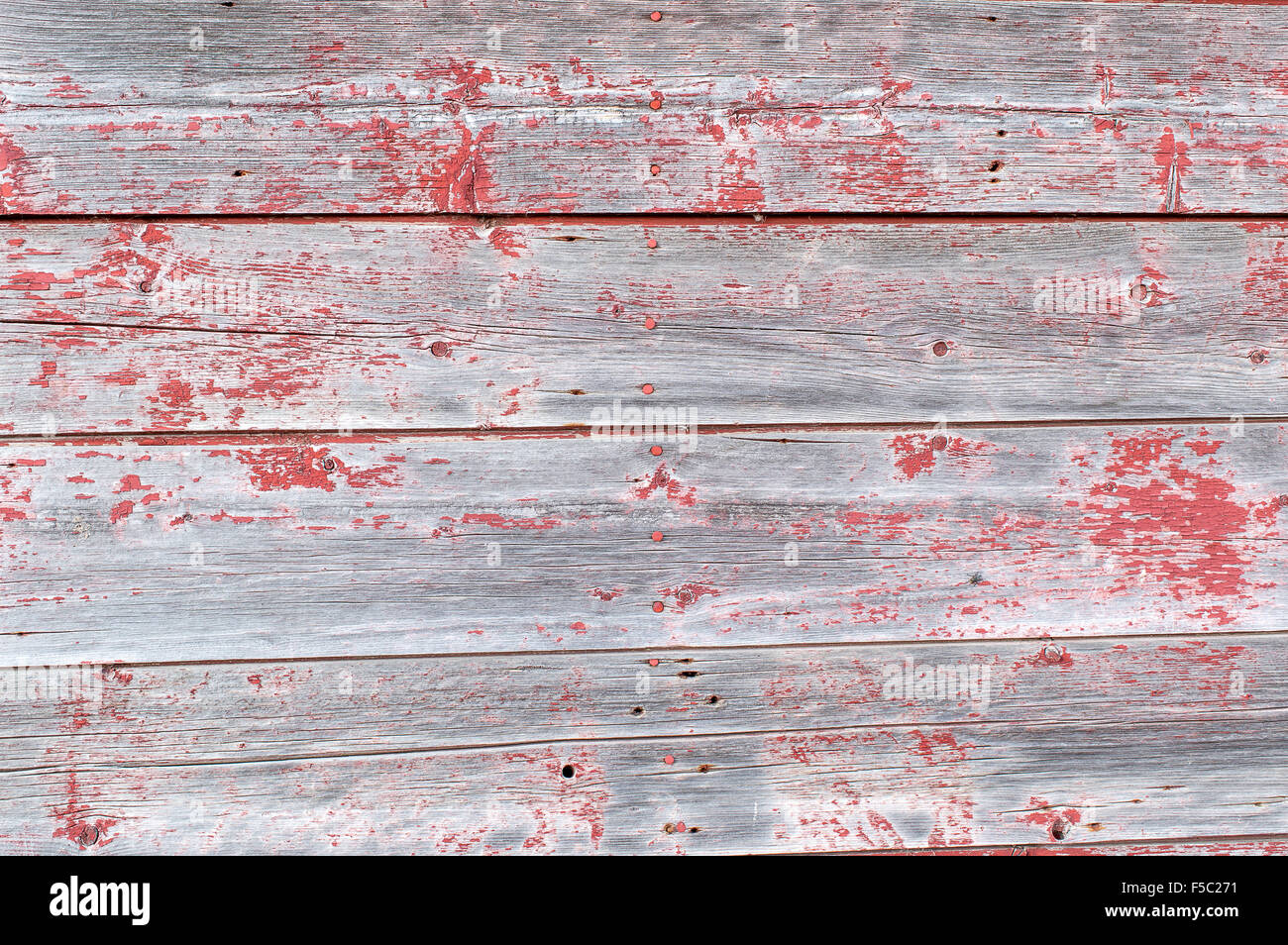 The red paint that once covered these planks is now faded and peeled ...
