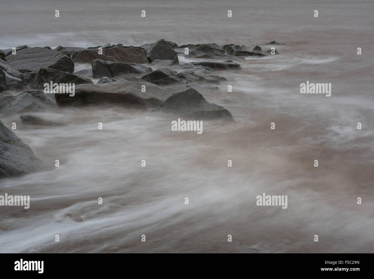 large rocks in the sea surrounded by misty waves Stock Photo - Alamy