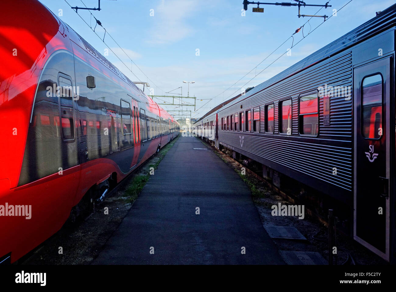 Two railway trains on each side of an empty platform in Central station ...
