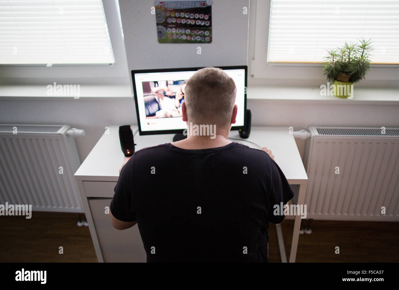Dortmund, Germany. 27th Oct, 2015. A teenage boy sits in front of a ...