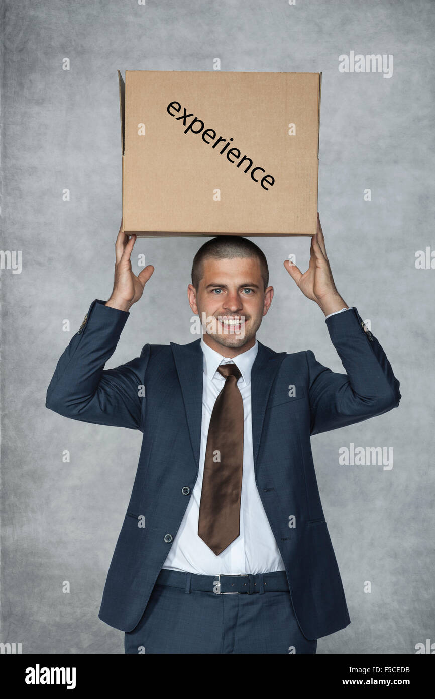 businessman with a box of experience on his head, smiling and happy ...