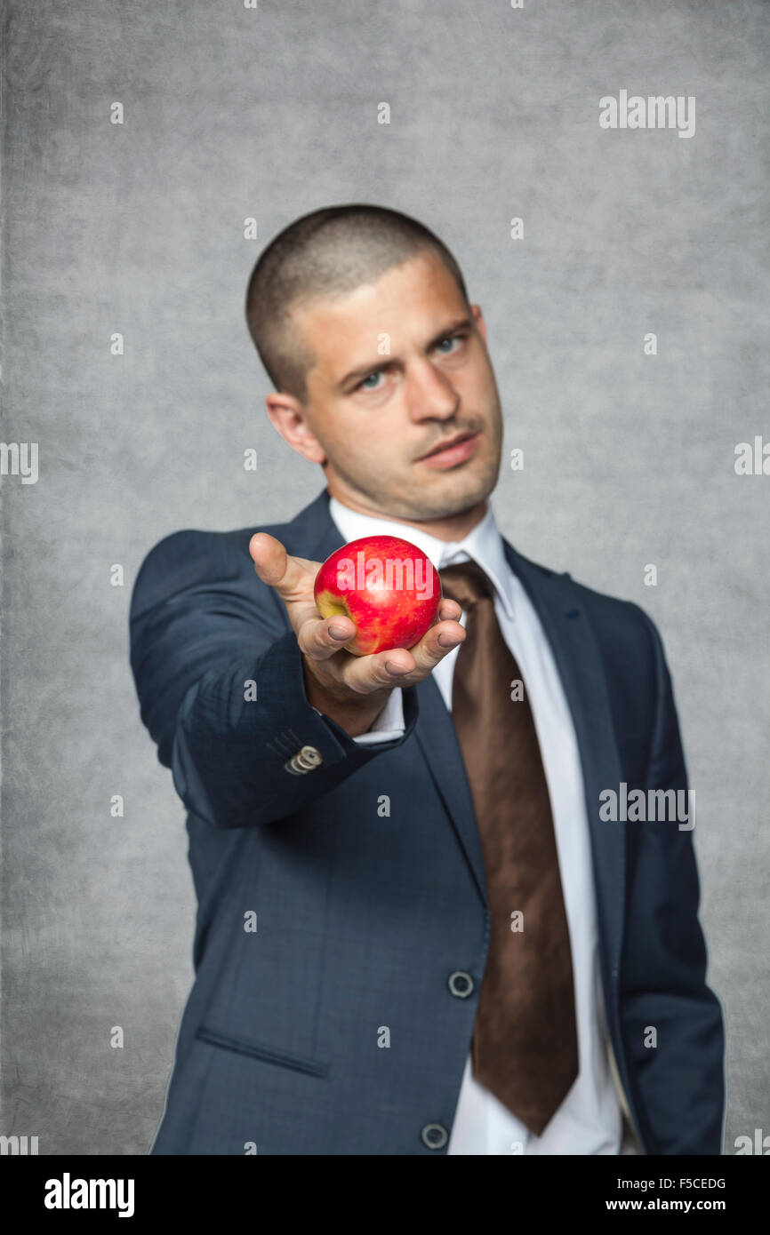 businessman giving apple for you Stock Photo - Alamy