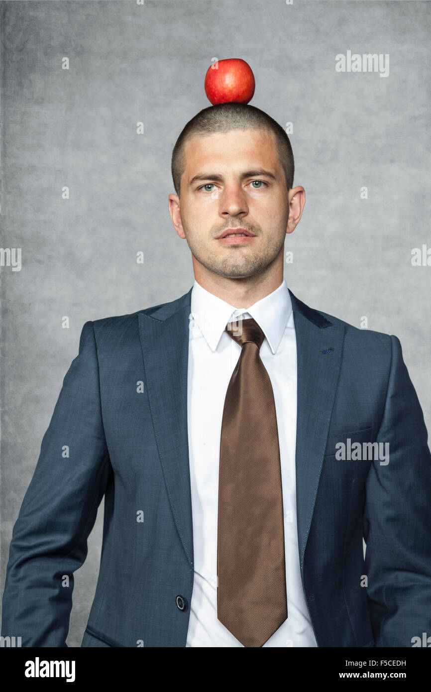 apple on the head of young businessman Stock Photo - Alamy