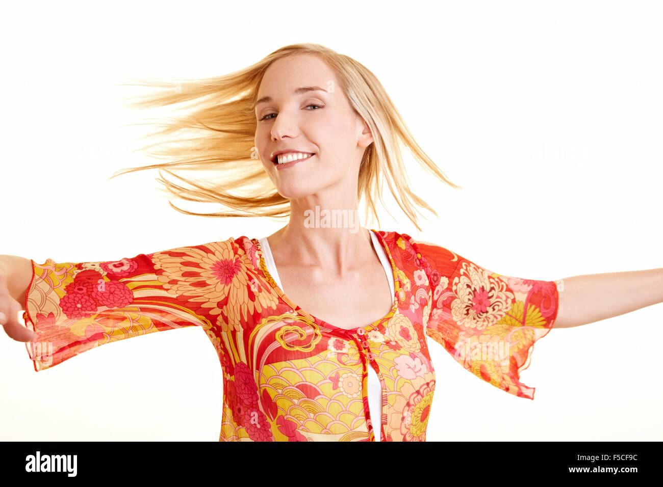 Happy woman with long hair turning around Stock Photo - Alamy