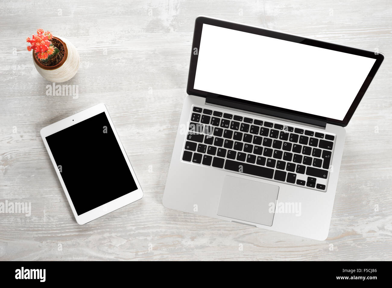 The laptop with the notepad on the desk in the office Stock Photo - Alamy