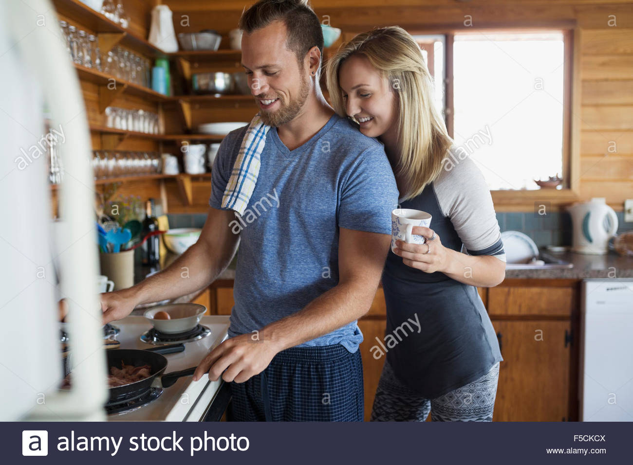 Woman cooking breakfast hi-res stock photography and images - Alamy
