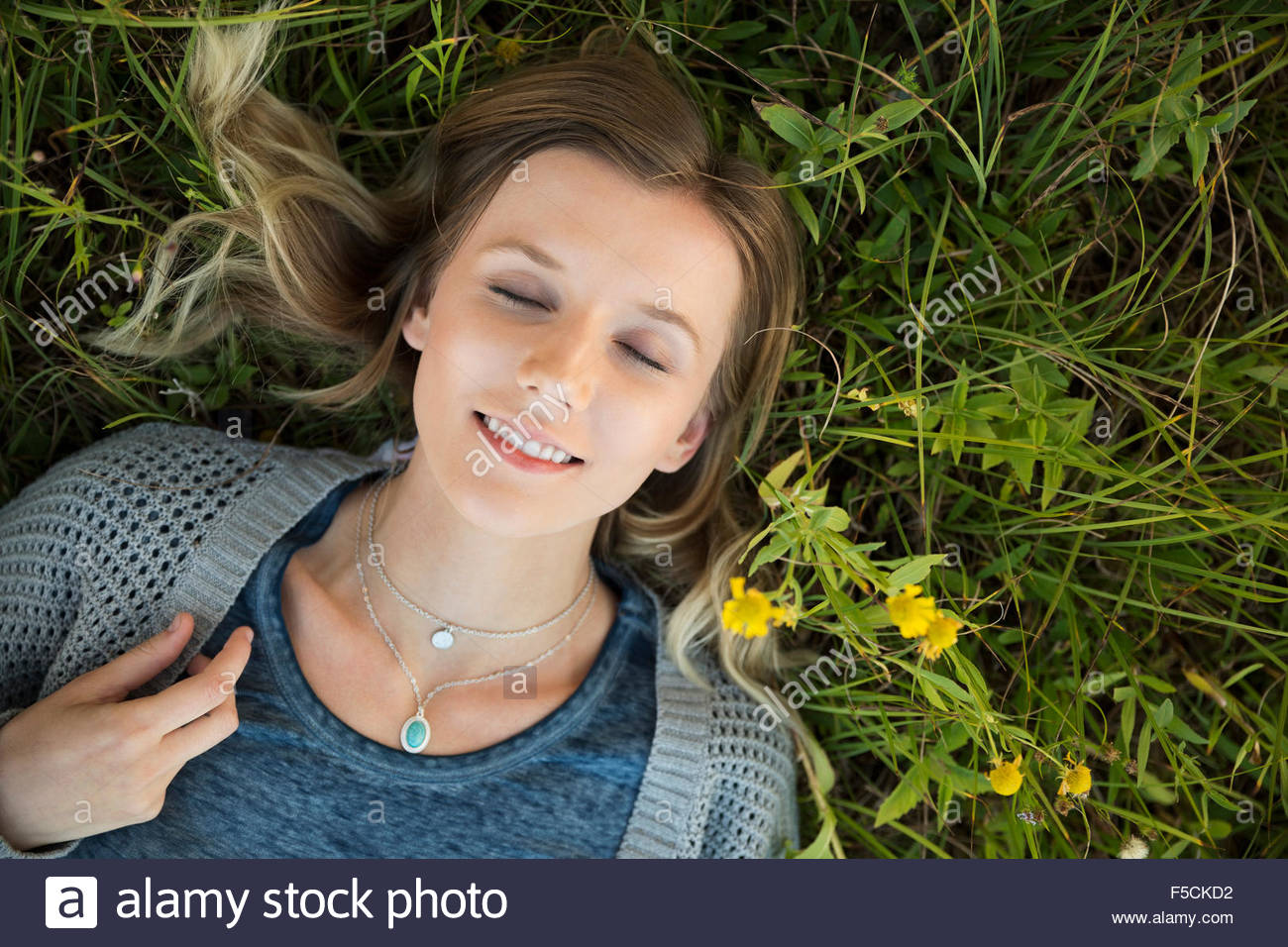 Woman laying grass hi-res stock photography and images - Alamy
