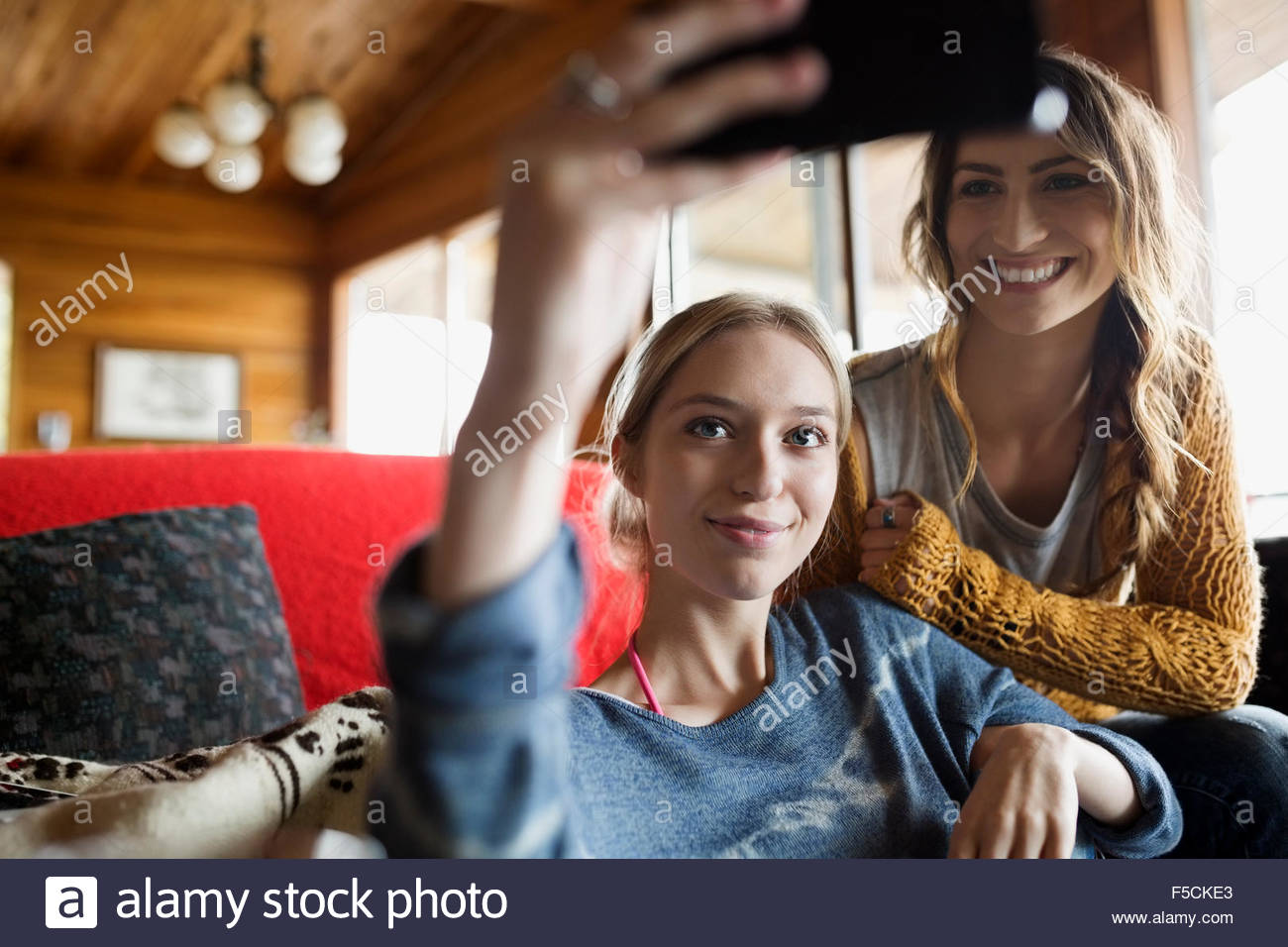 Young women taking selfie with camera phone Stock Photo - Alamy
