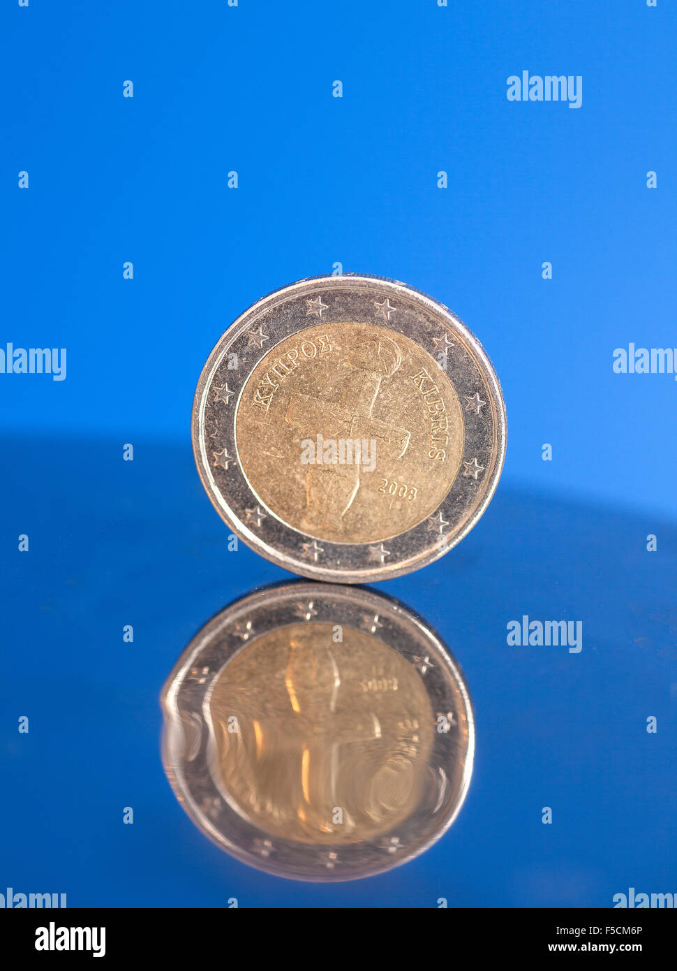 Two euro coin on blue background Stock Photo - Alamy