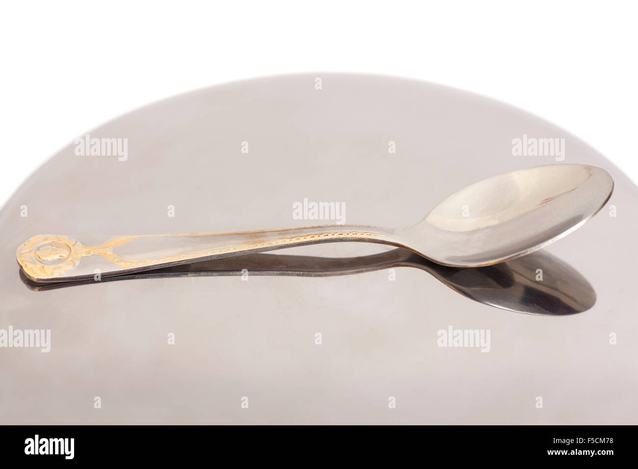 Chrome spoon on white background Stock Photo - Alamy