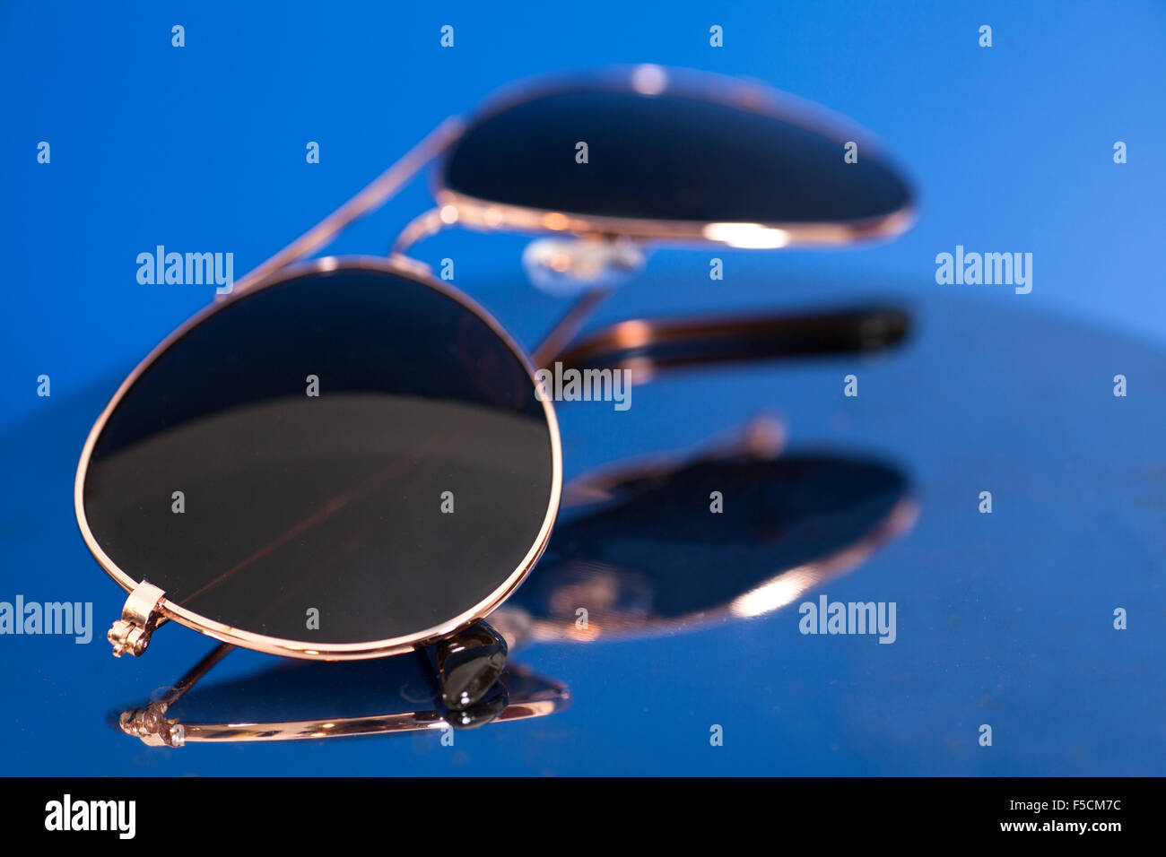Sunglasses On Blue Background Stock Photo - Alamy