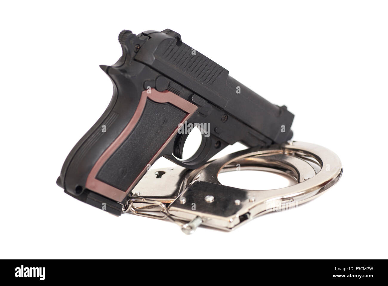 Gun and handcuffs isolated on white background Stock Photo - Alamy